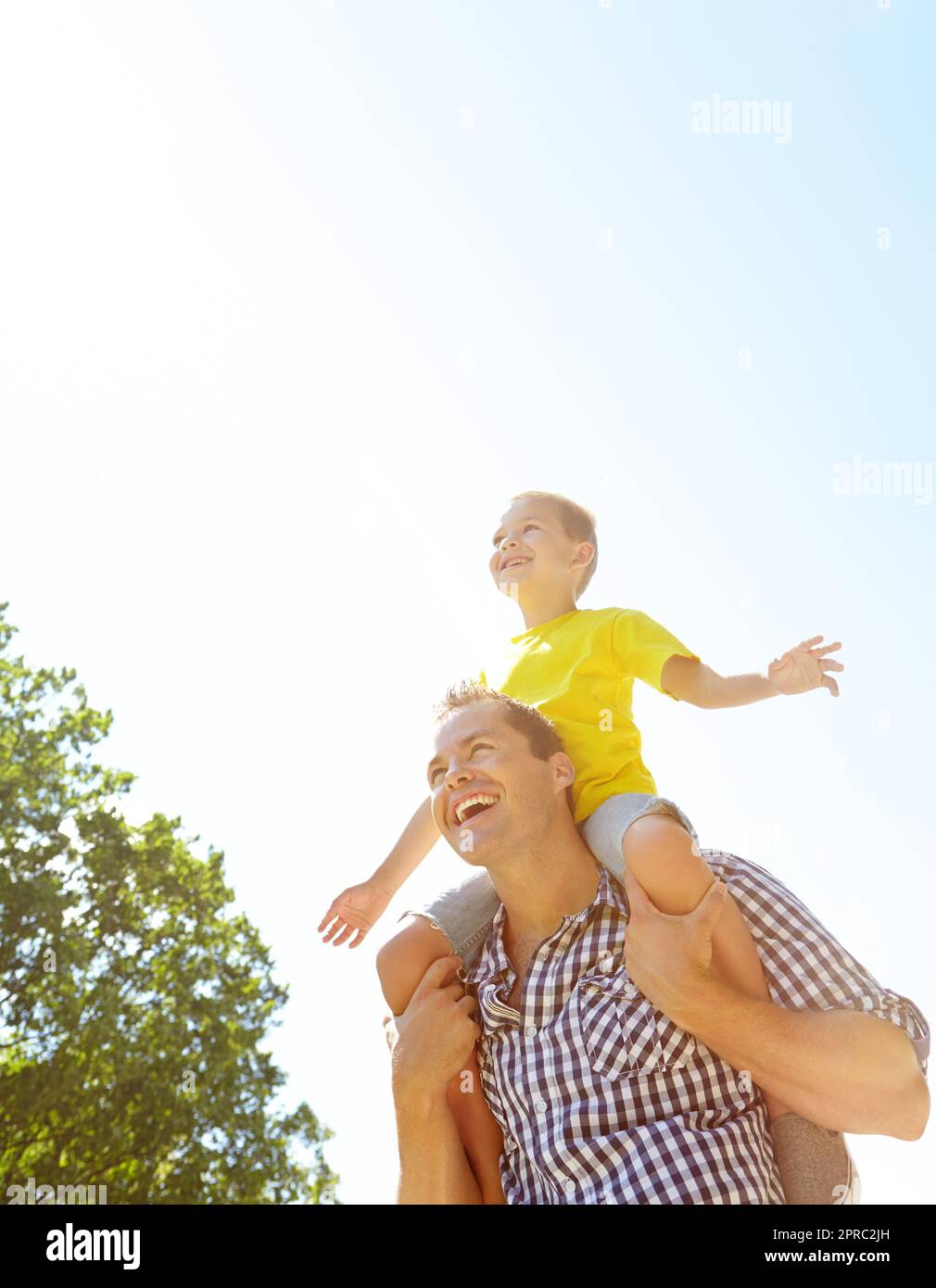 Loving nature together. Cute young boy being carried on his fathers ...