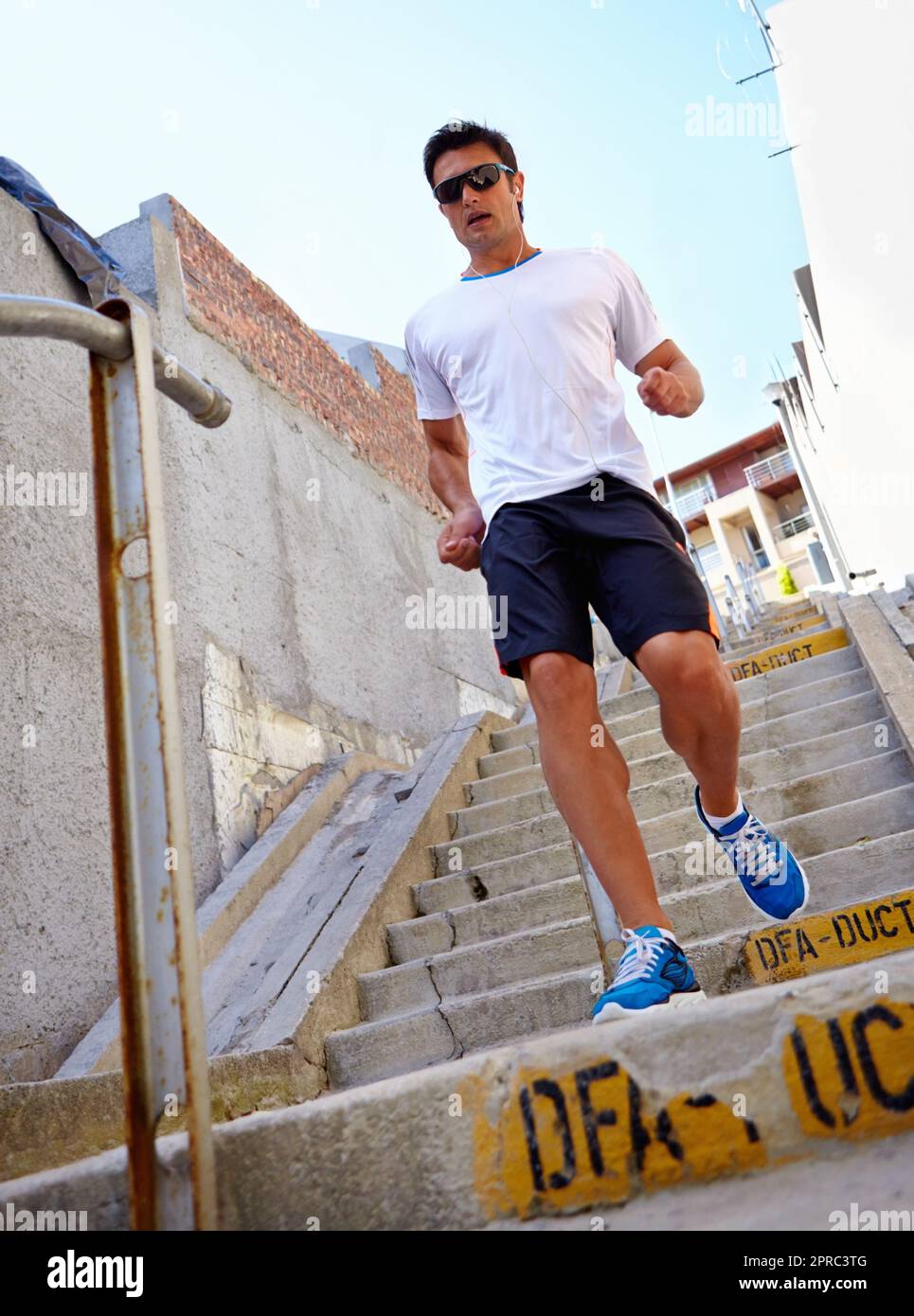Making the city into a training ground. a handsome young male athlete ...