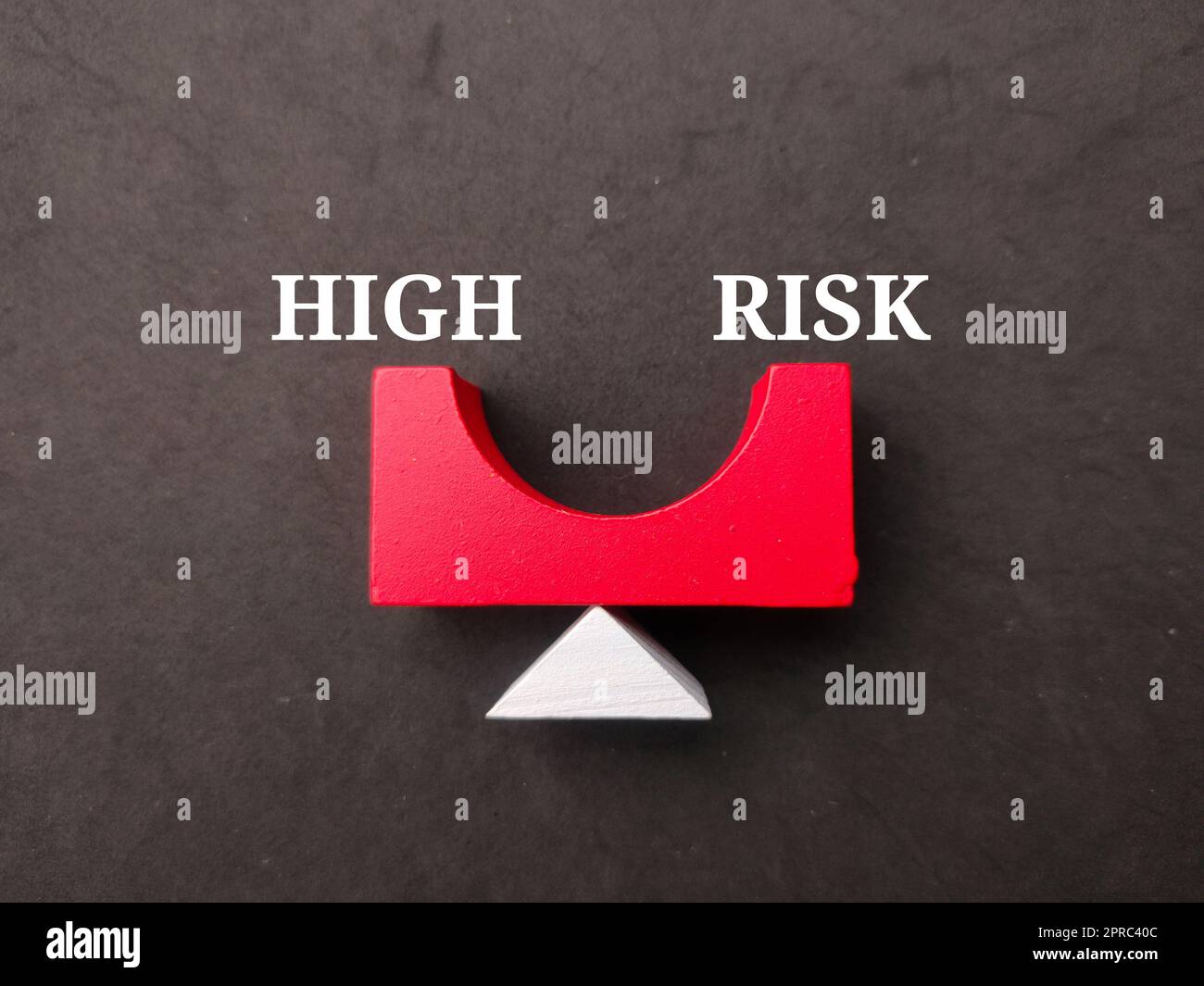 Colored wooden block with the word HIGH RISK Stock Photo - Alamy