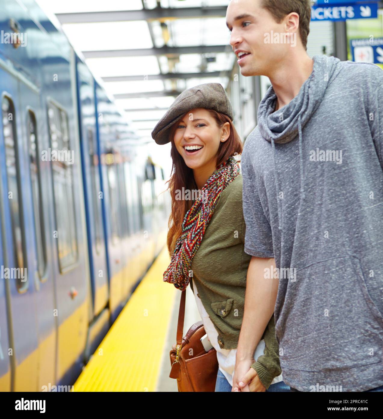 Excited for our new adventure. A laughing couple holding hands at a ...