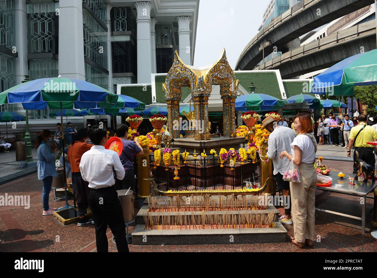 Thai people pray at the Erawan Shrine in Chid Lom, Bangkok, Thailand ...