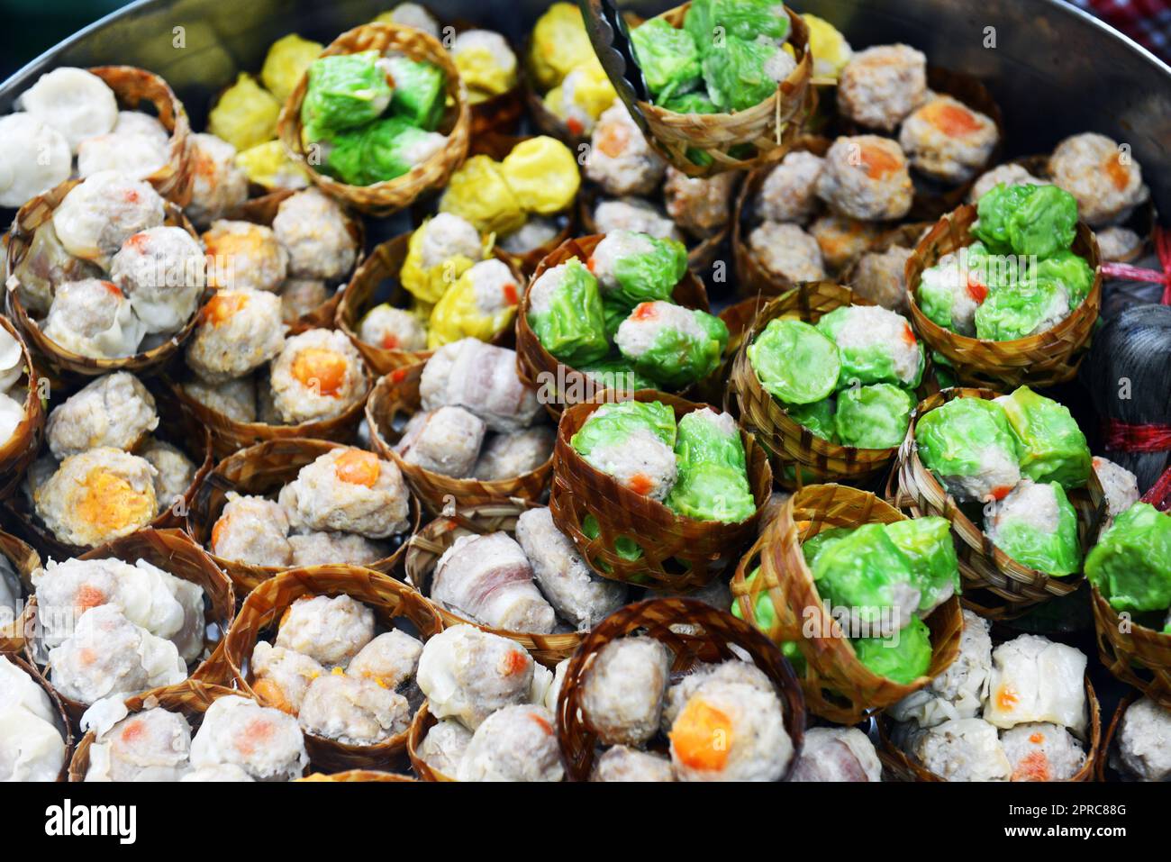A colorful street food market on the railway track under the Chalerm ...