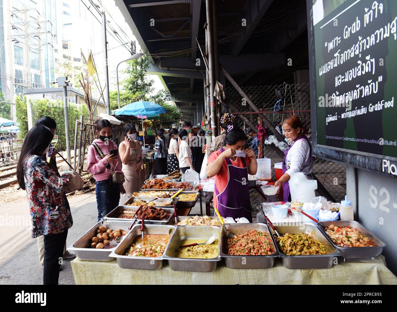 A colorful street food market on the railway track under the Chalerm ...