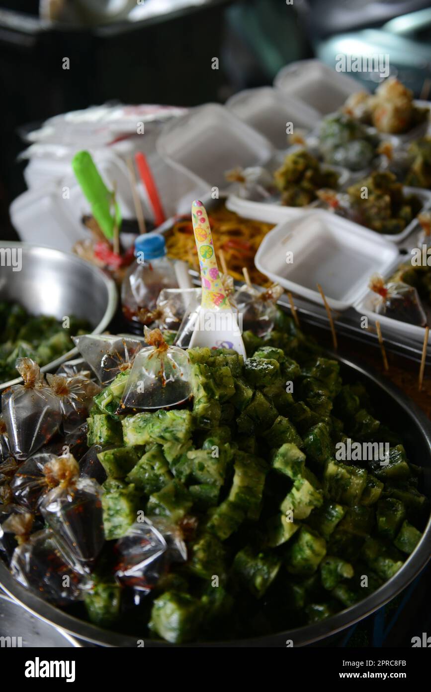A colorful street food market on the railway track under the Chalerm ...