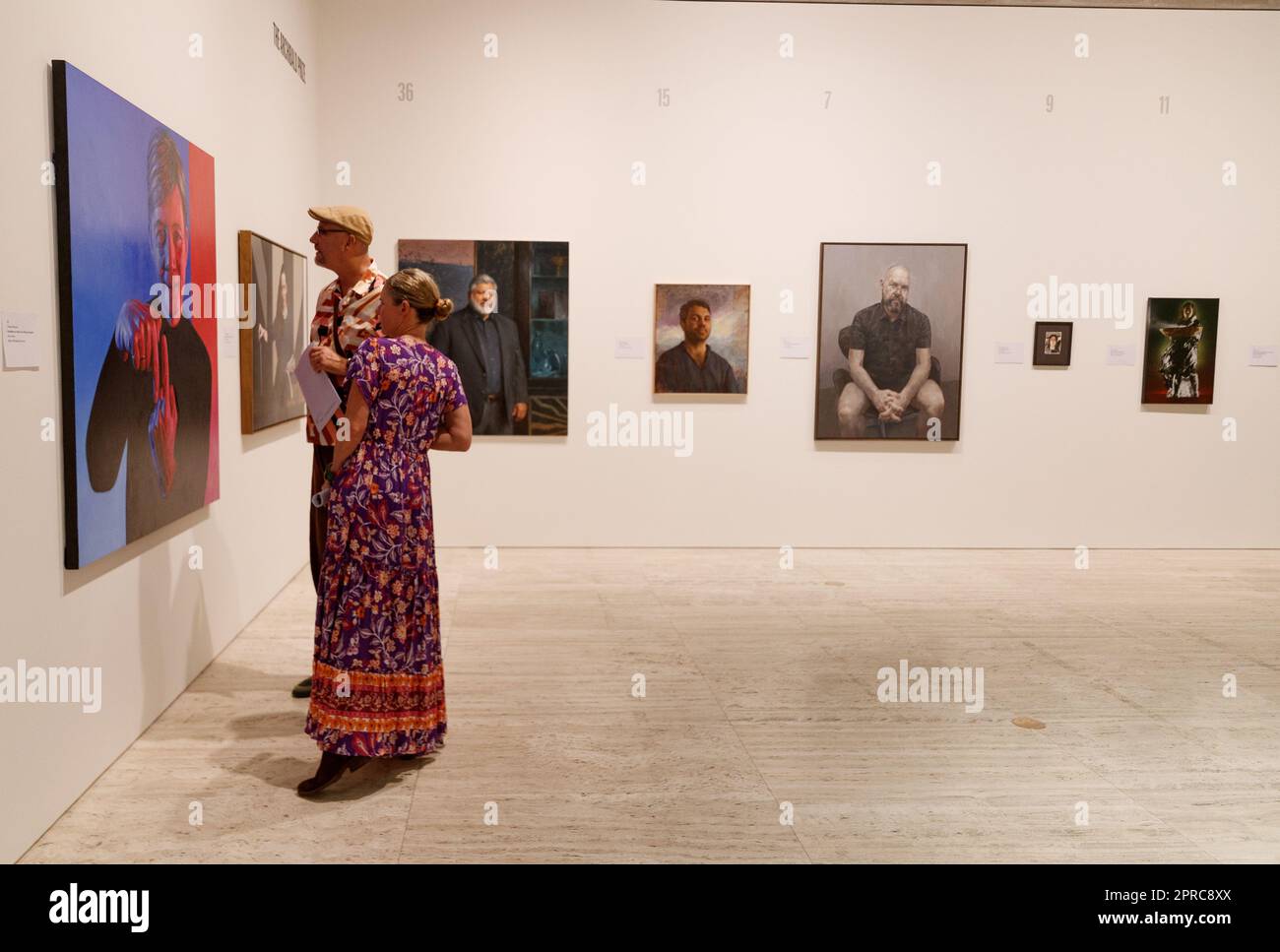 People walk through the Archibald Portrait Prize exhibition at the Art ...
