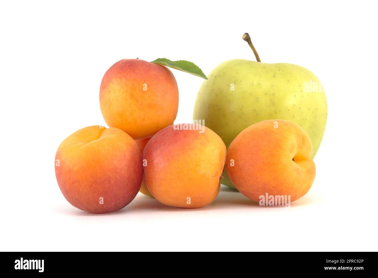 Whole ripe apricots and green apple isolated on a white background ...