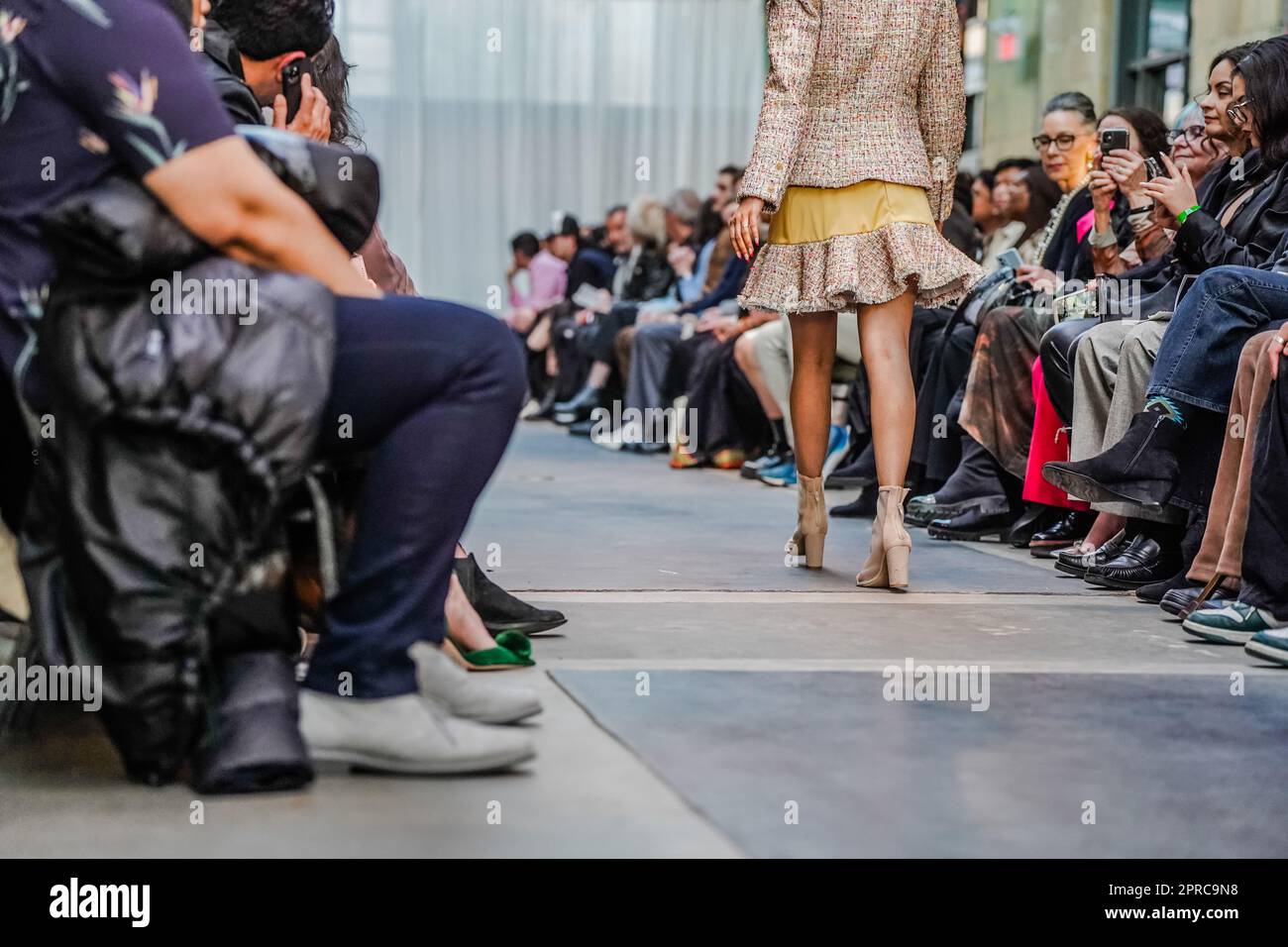 Low angle shot of a fashion runway showing only an anonymous female ...