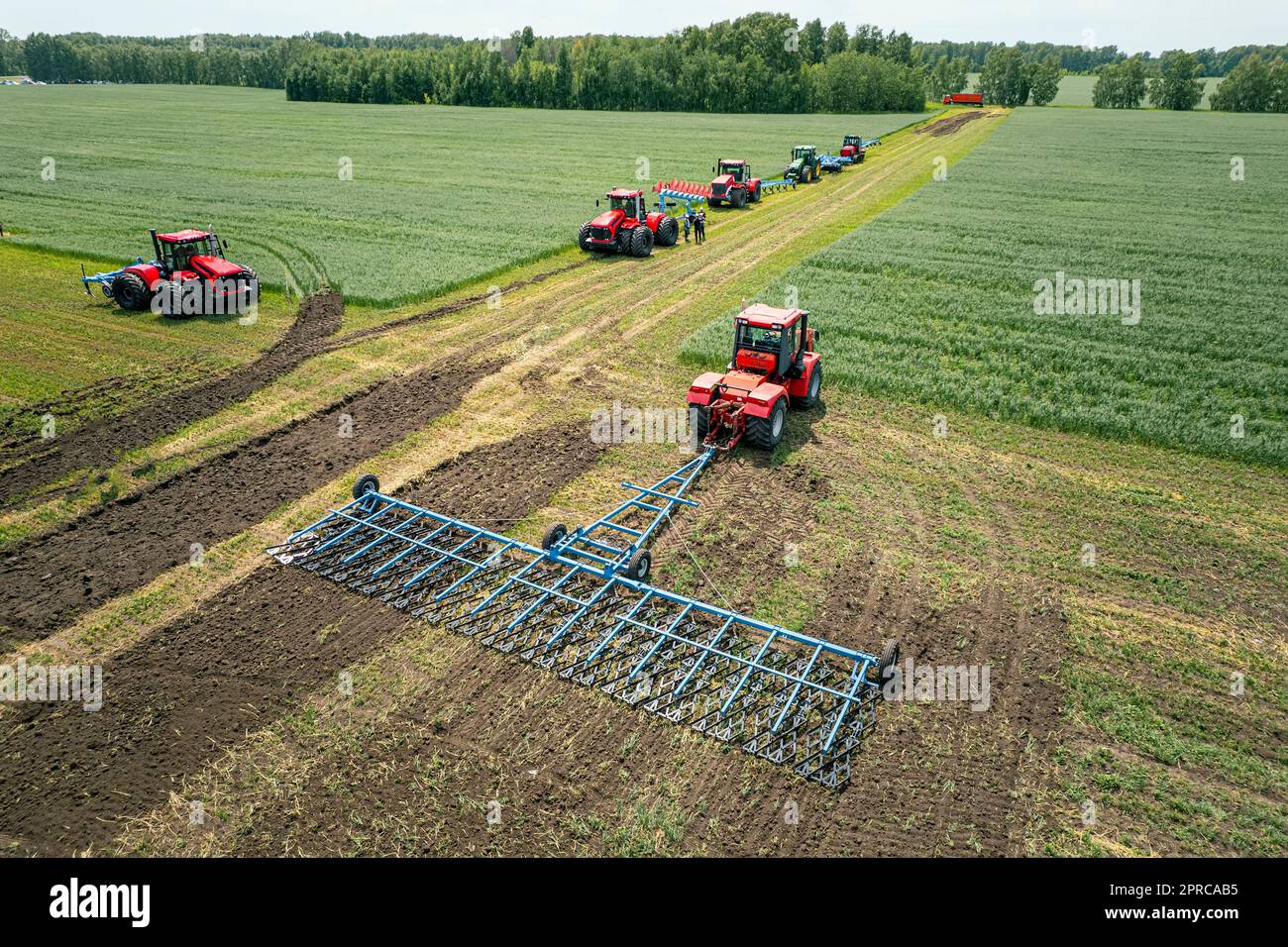 Agriculture machine harvesting crop in fields. Tractor pulls a ...