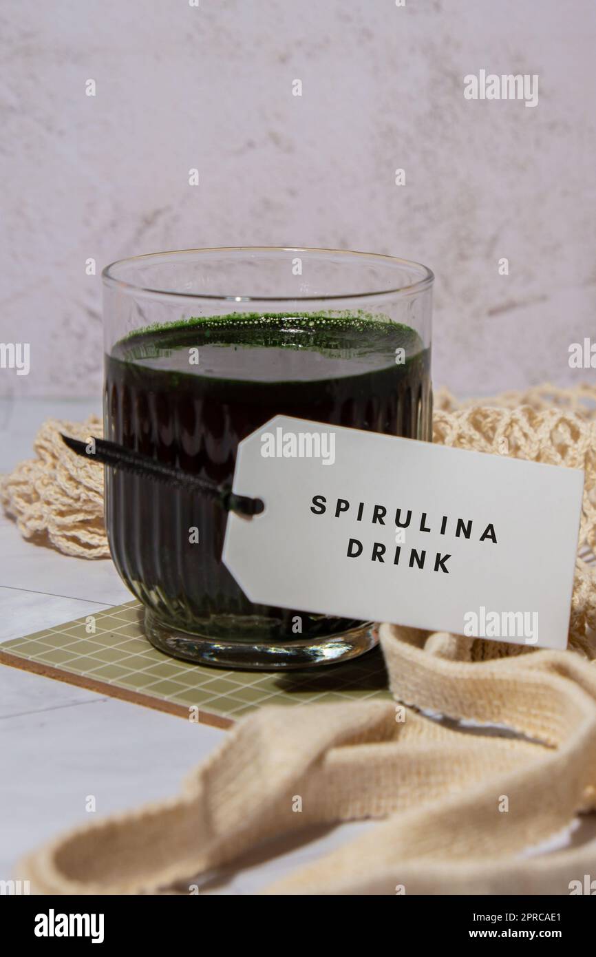 Blue-green algae Chlorella and spirulina powder drink with paper note ...