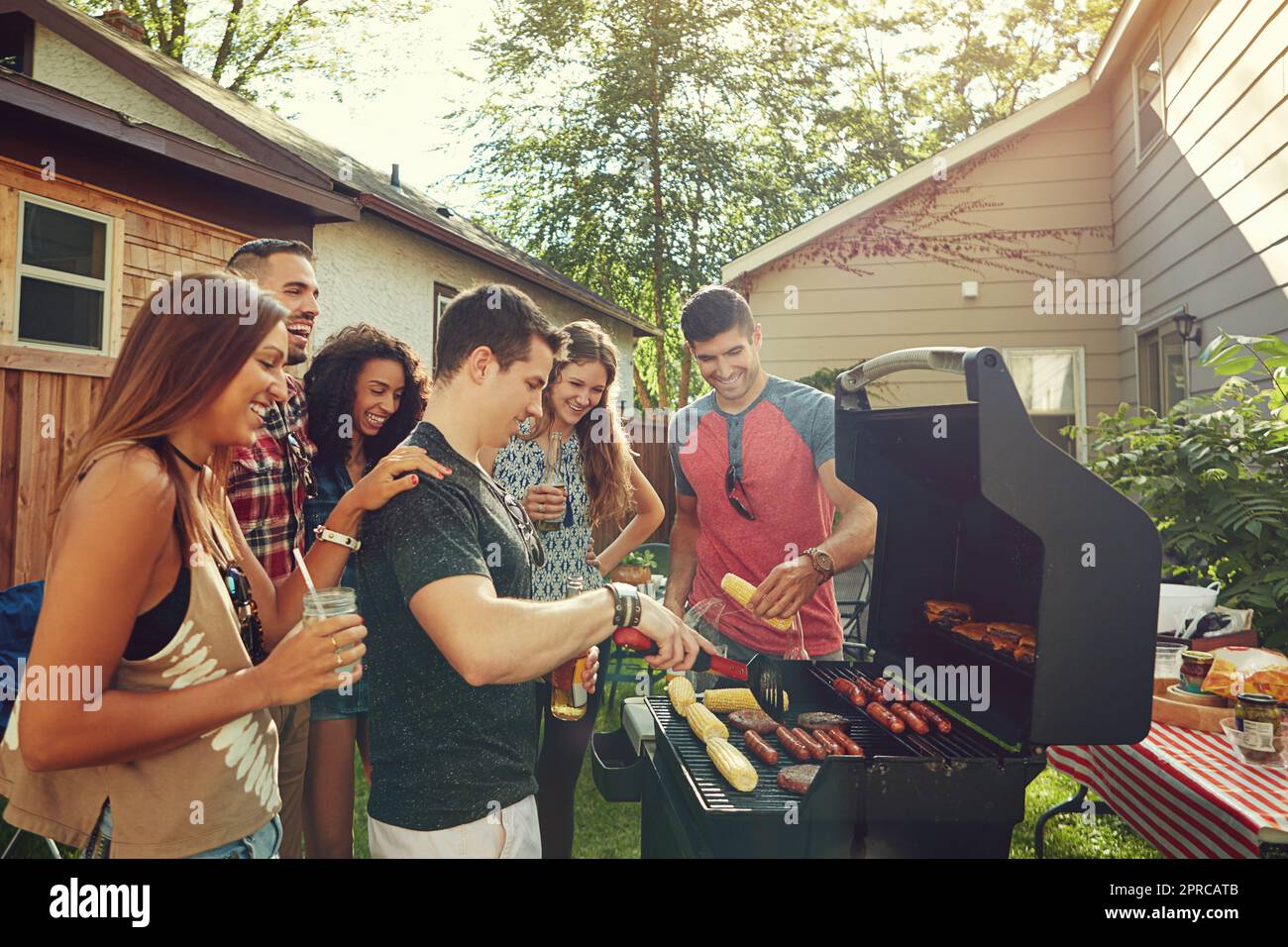People standing around barbecue grill hi-res stock photography and ...