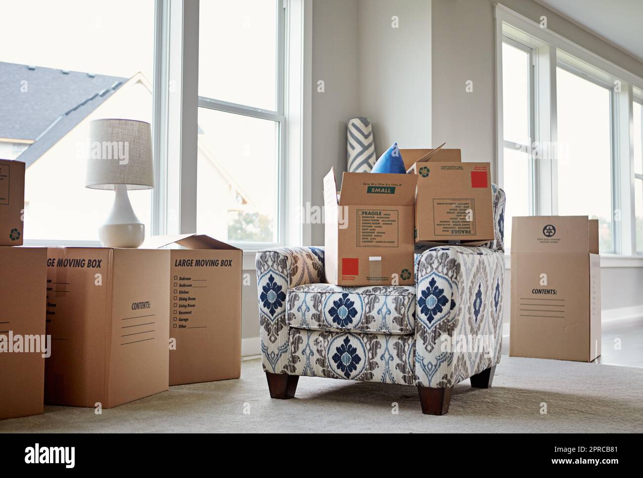 Time to unpack...packed cardboard boxes and furniture on moving day ...