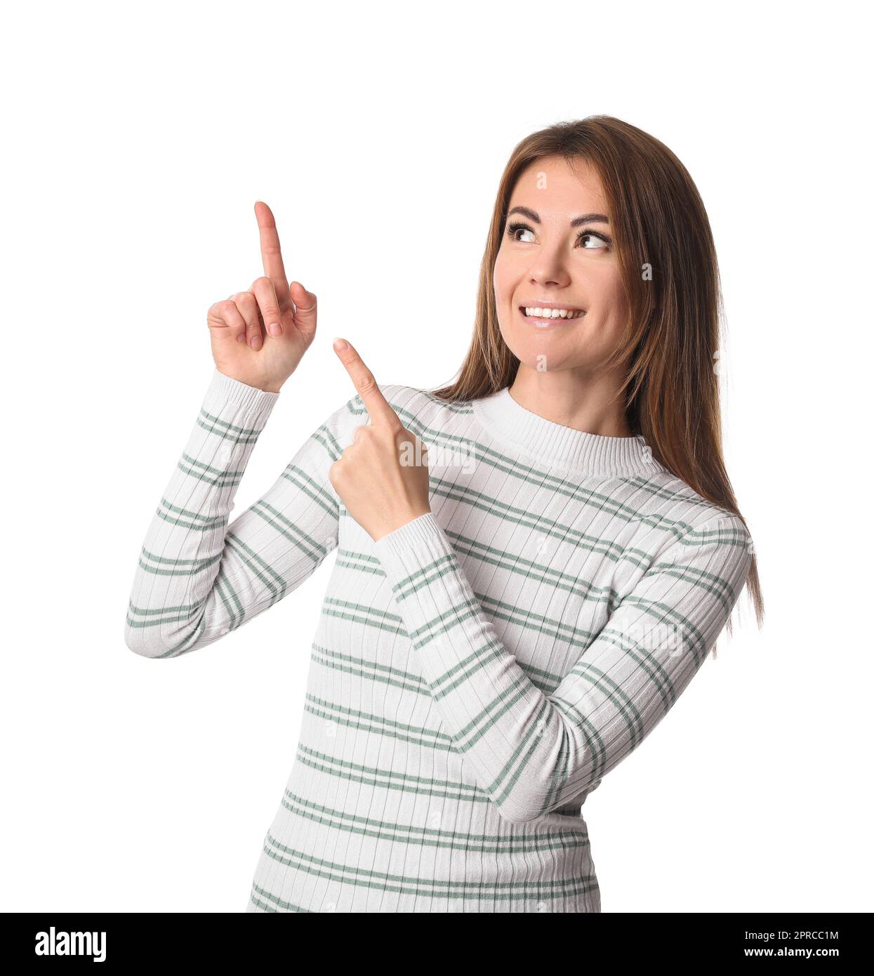 Beautiful woman in striped shirt pointing at something on white ...