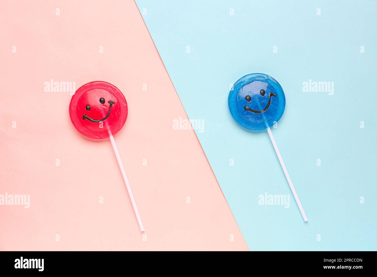 Red and blue lollipops with smiles on colorful background Stock Photo ...