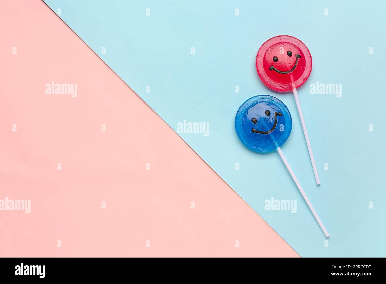 Red and blue lollipops with smiles on colorful background Stock Photo ...
