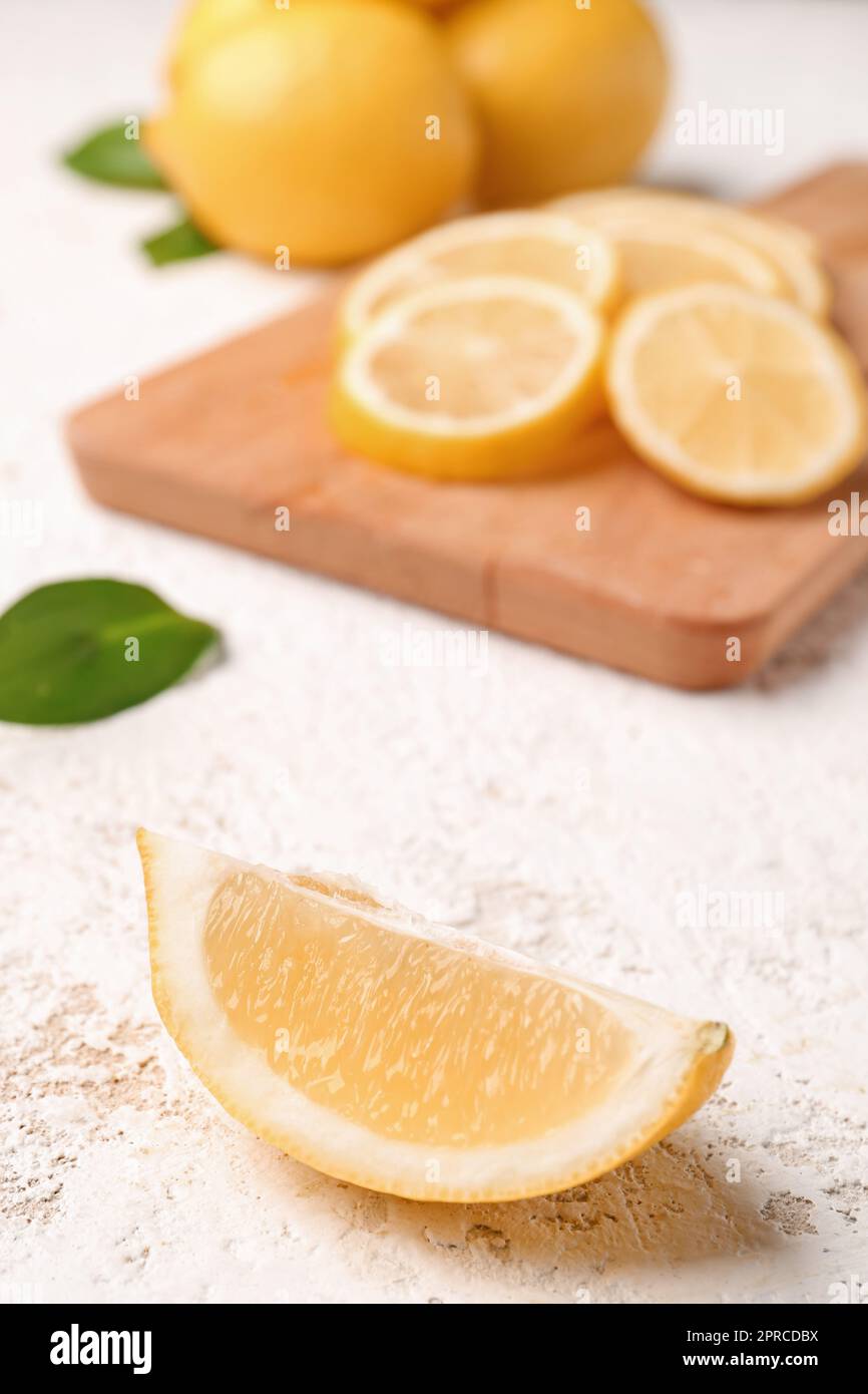 Board with fresh lemons on white background Stock Photo - Alamy