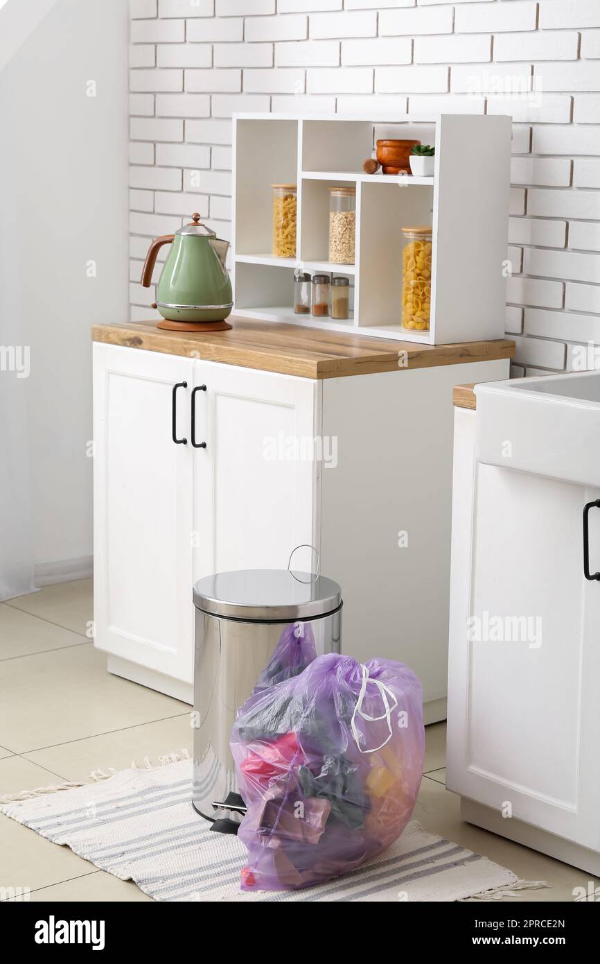 Trash bin and full garbage bag in interior of modern kitchen Stock ...