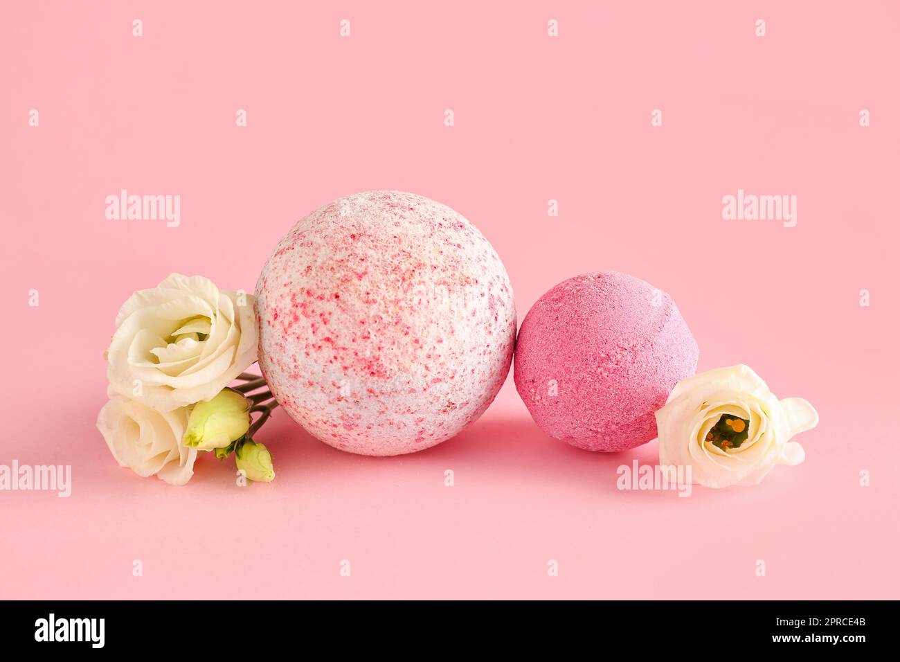 Bath bombs with roses on pink background Stock Photo - Alamy