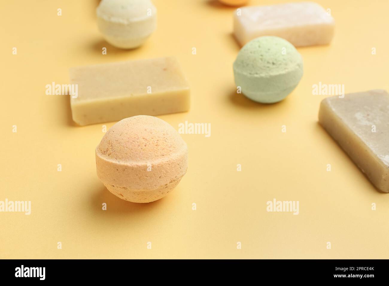 Bath bombs with soap bars on yellow background, closeup Stock Photo - Alamy
