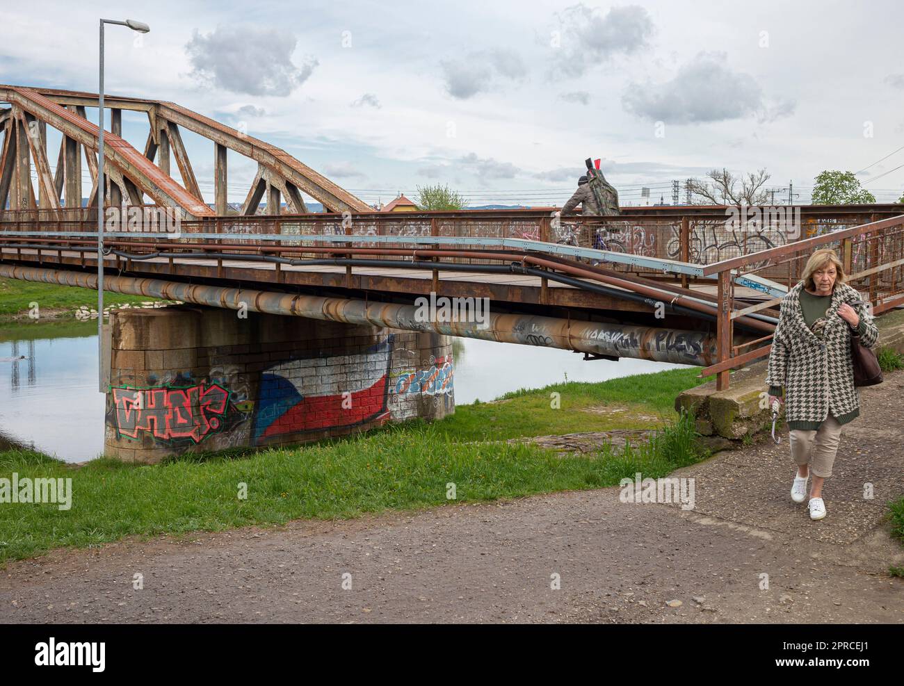 Woman and railway bridge Stock Photo - Alamy