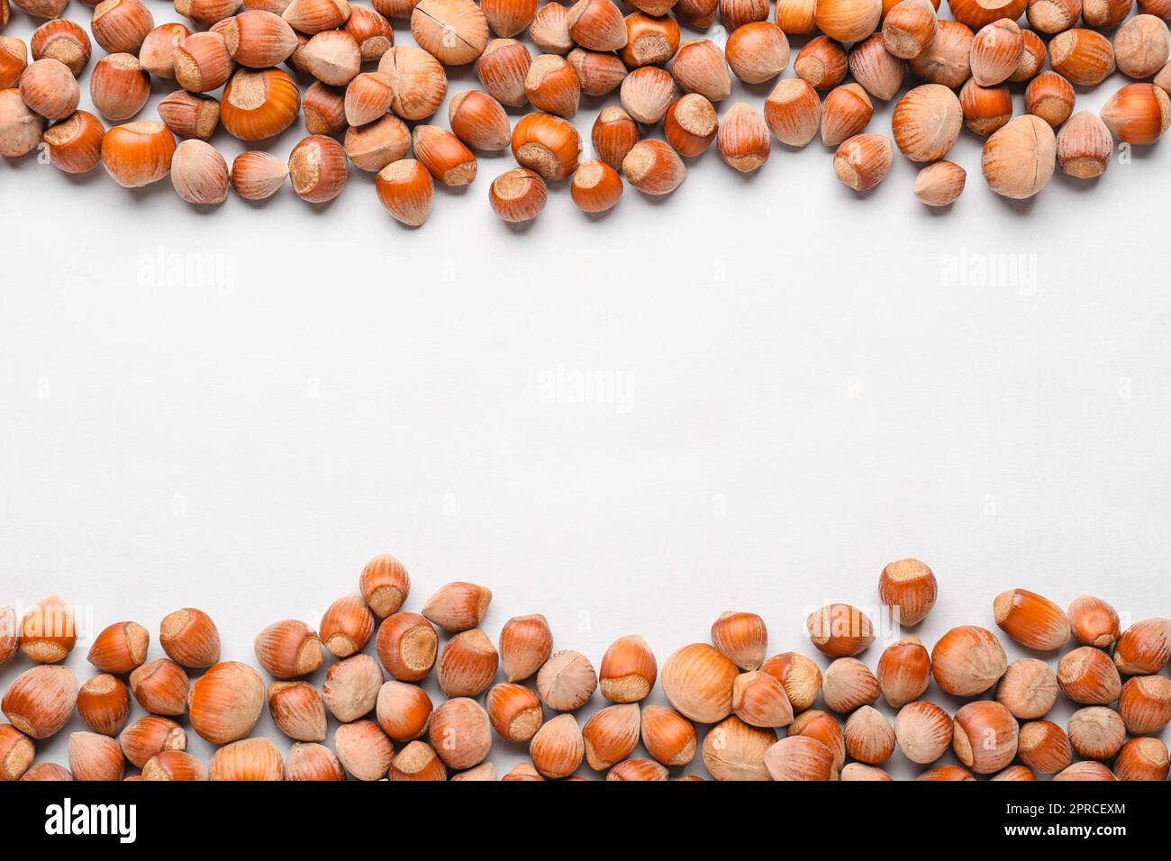 Frame made of shelled hazelnuts on grey background Stock Photo - Alamy