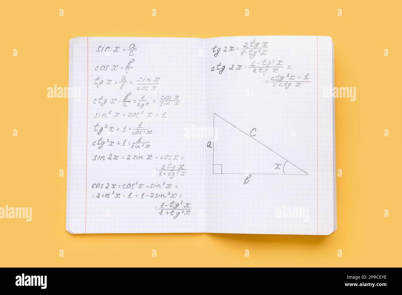 Copybook with maths formulas on yellow background Stock Photo - Alamy