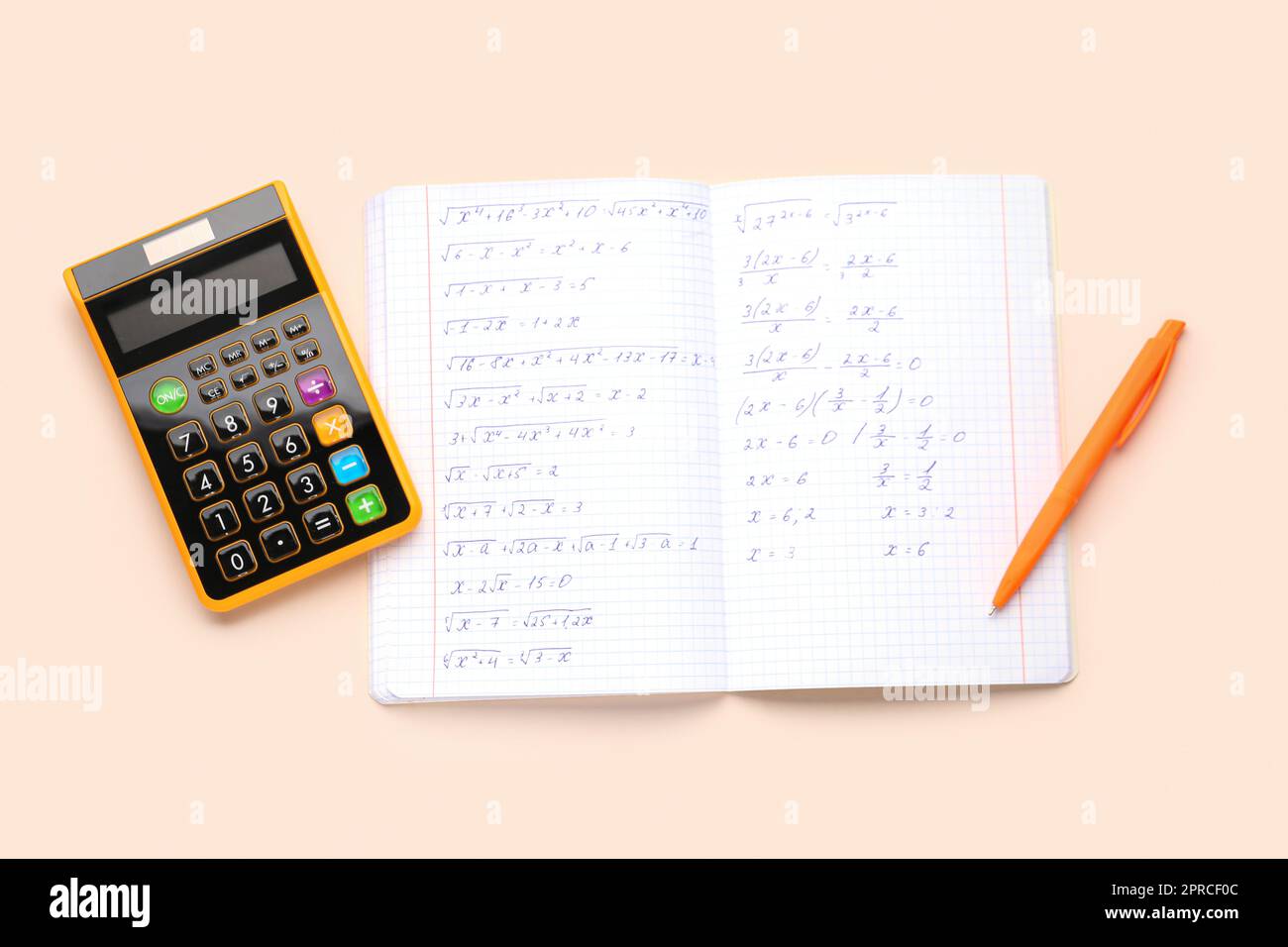 Copybook with maths formulas, calculator and pen on beige background ...