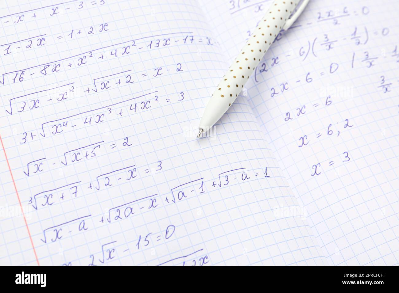 Copybook with maths formulas and pen, closeup Stock Photo - Alamy