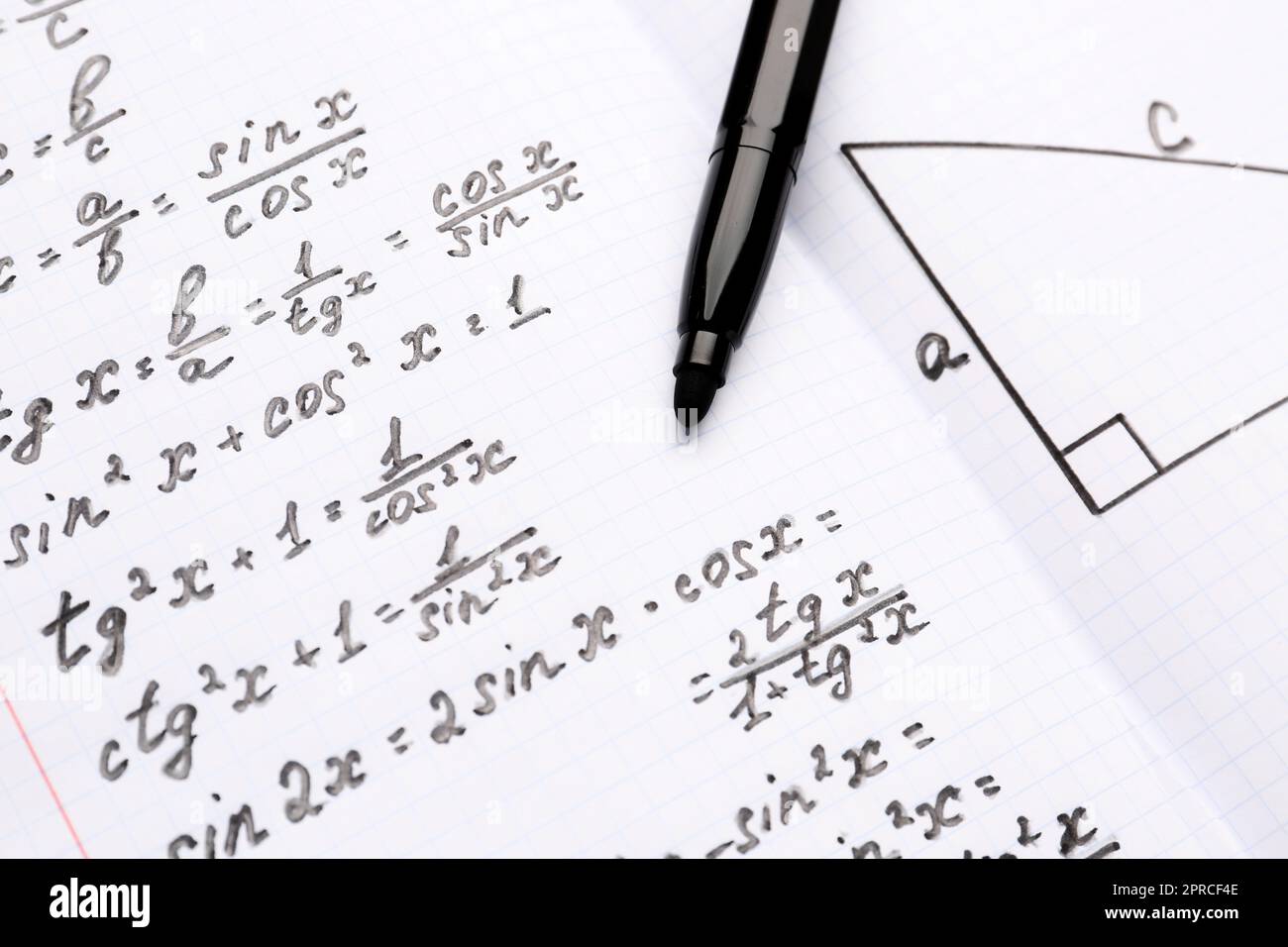 Copybook with maths formulas and pen, closeup Stock Photo - Alamy