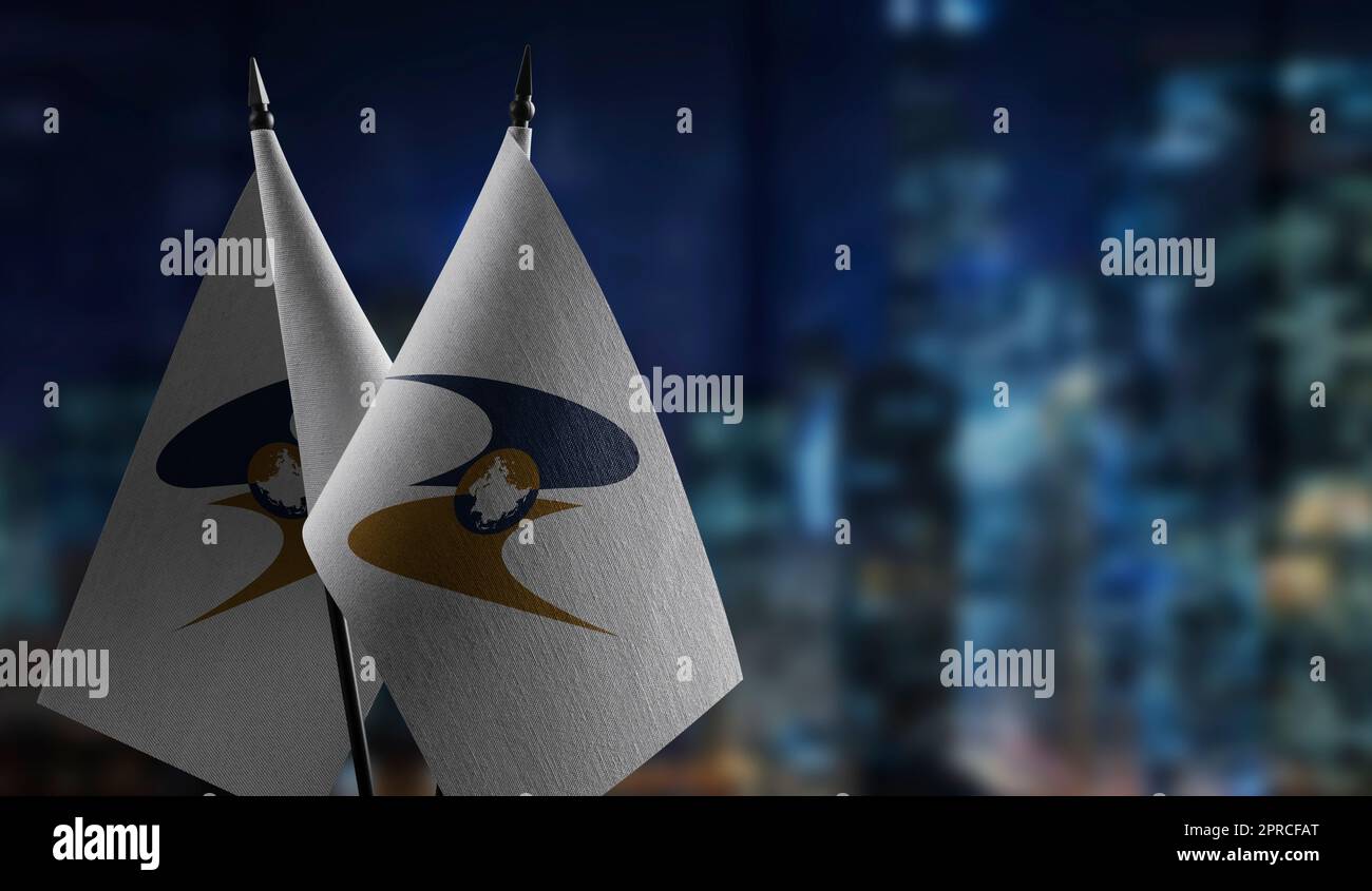Small flags of the Eurasian Economic Union on an abstract blurry ...