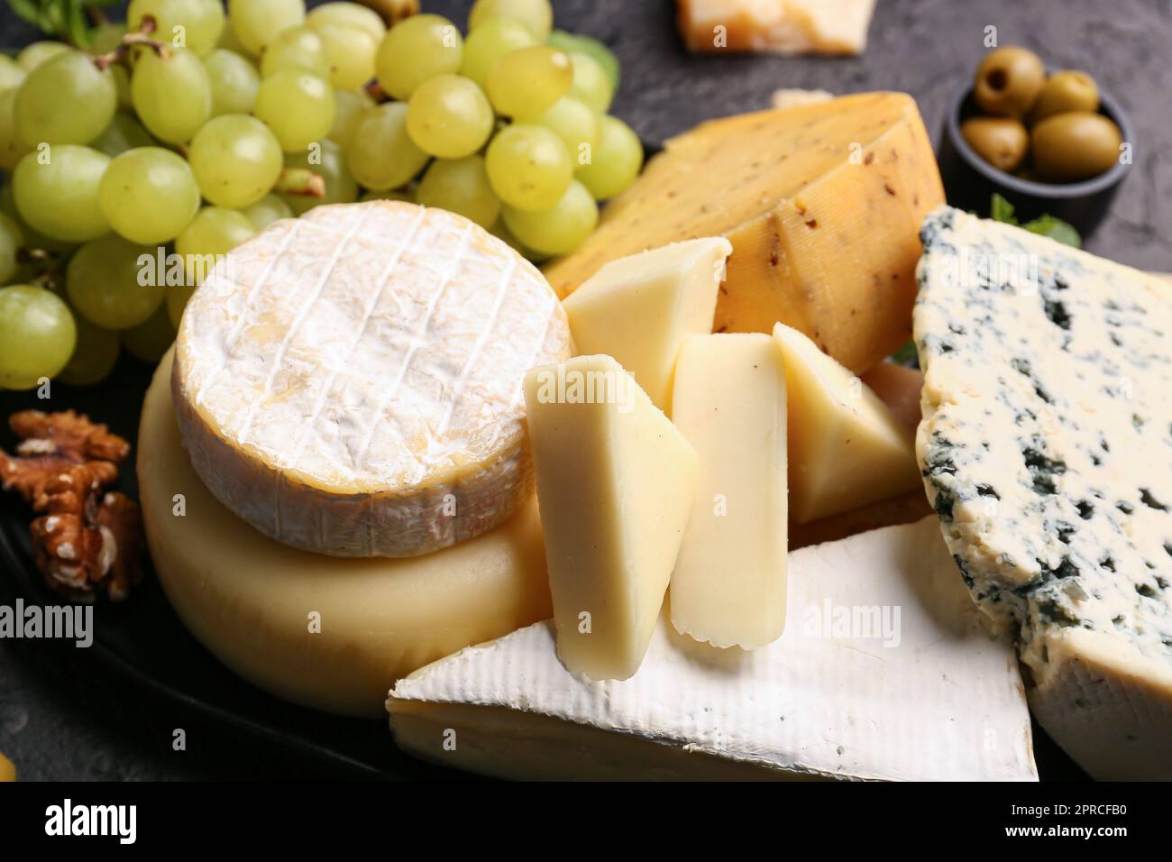 Different types of tasty cheese on table, closeup Stock Photo - Alamy