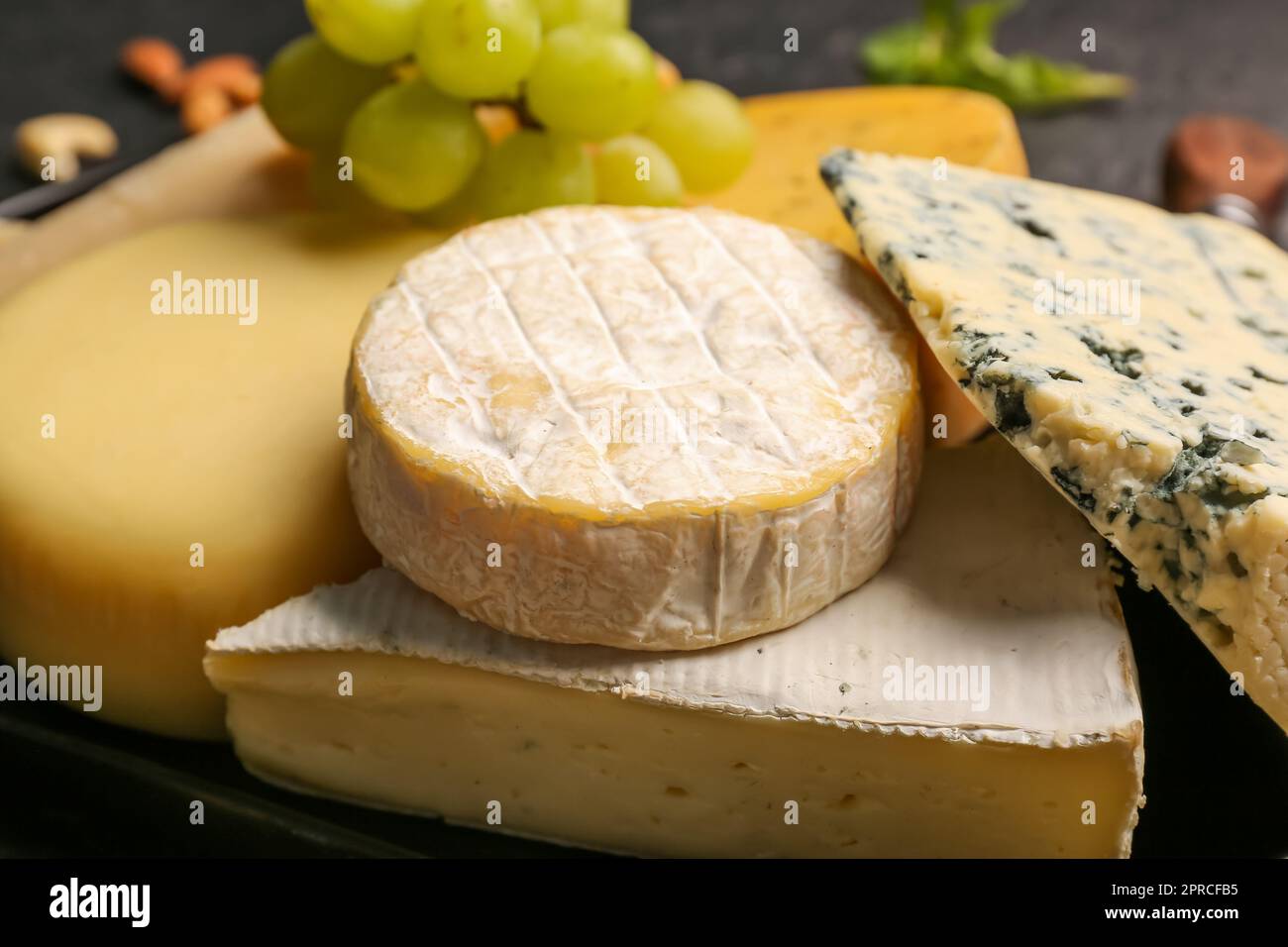 Different types of tasty cheese on table, closeup Stock Photo - Alamy