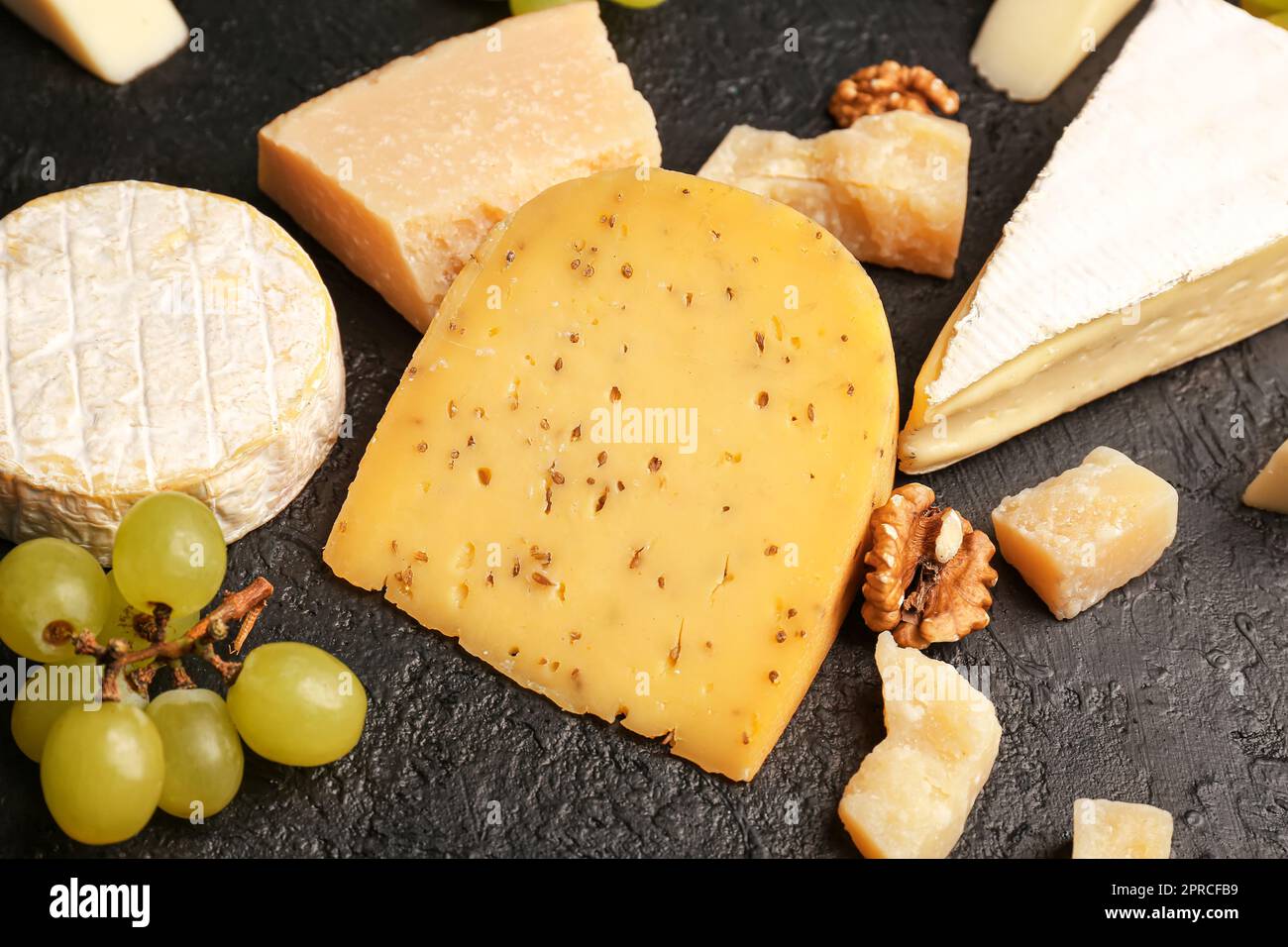 Different types of tasty cheese on dark background Stock Photo - Alamy