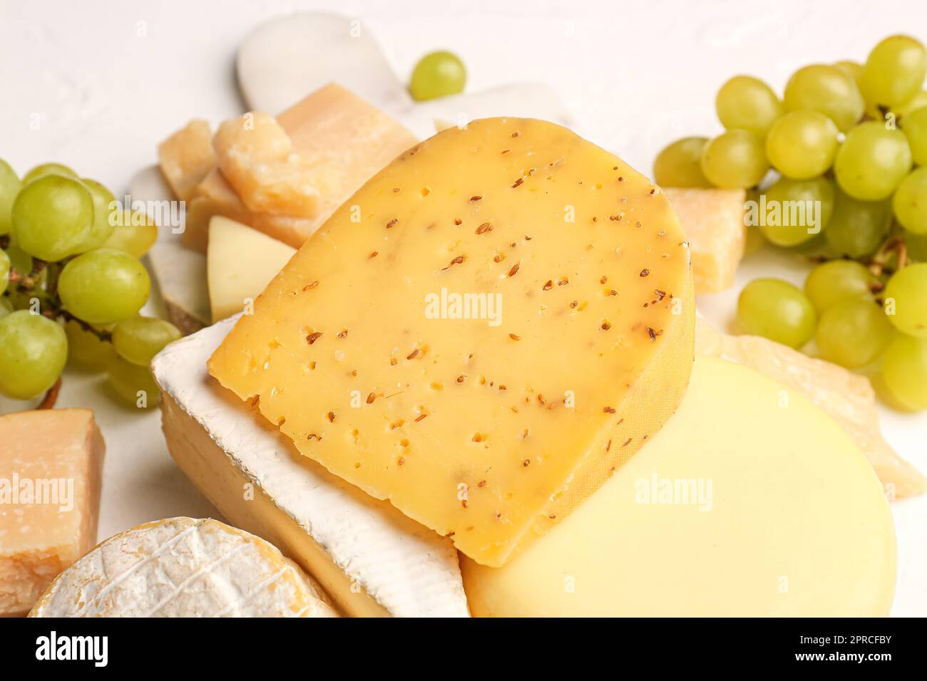 Different types of tasty cheese on light background, closeup Stock ...