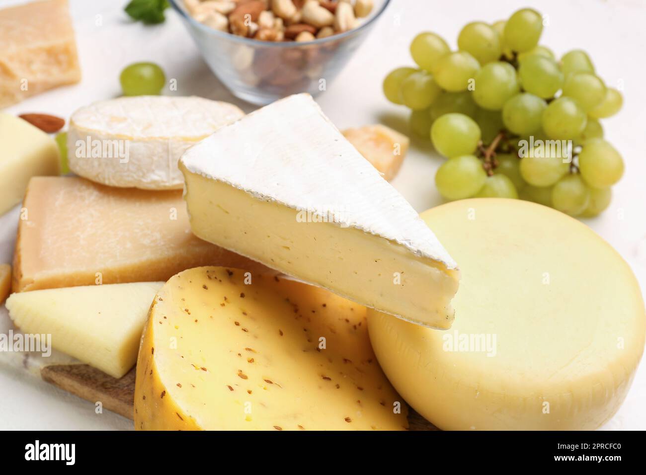 Different types of tasty cheese on light background, closeup Stock ...