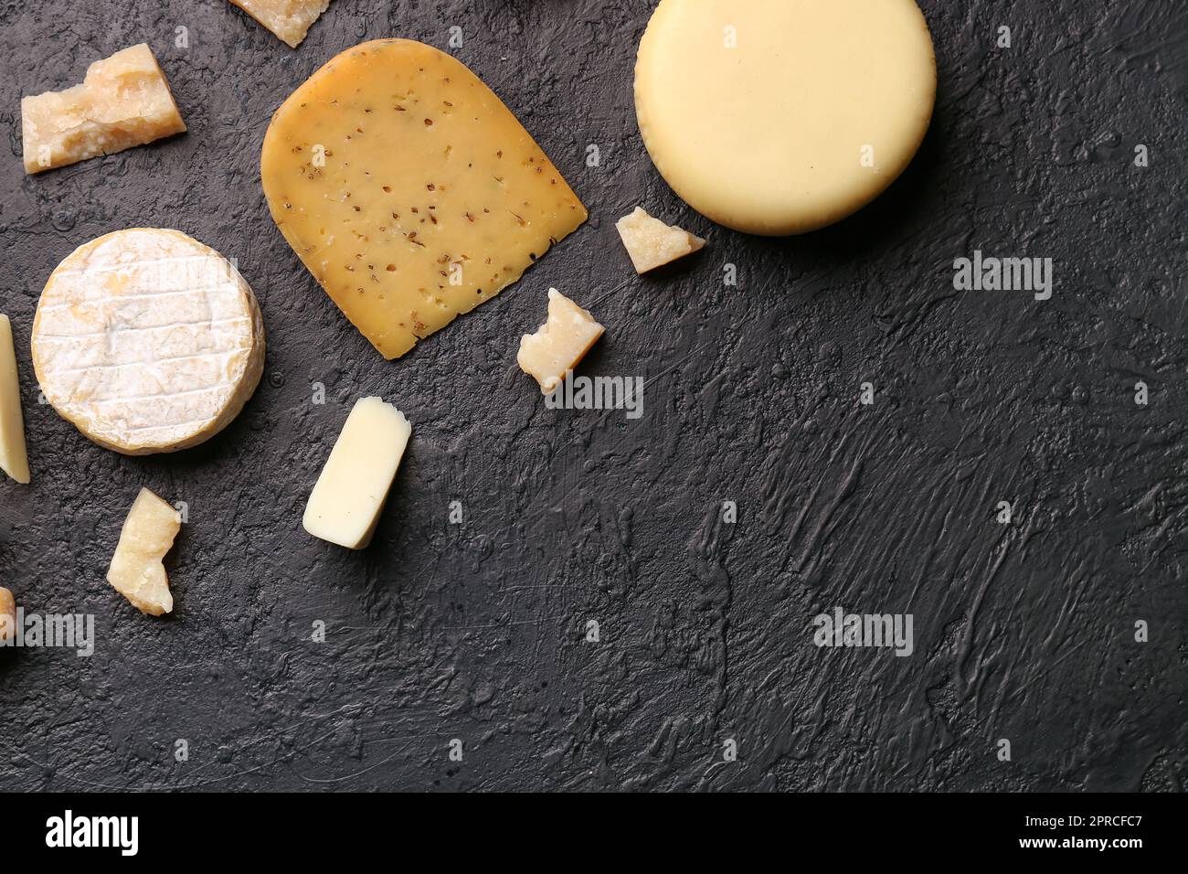 Different types of tasty cheese on dark background Stock Photo - Alamy