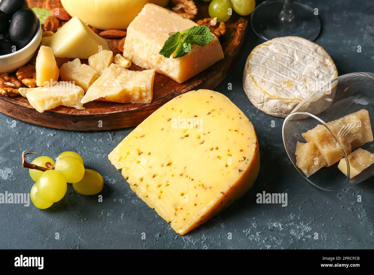 Different types of tasty cheese on blue background Stock Photo - Alamy