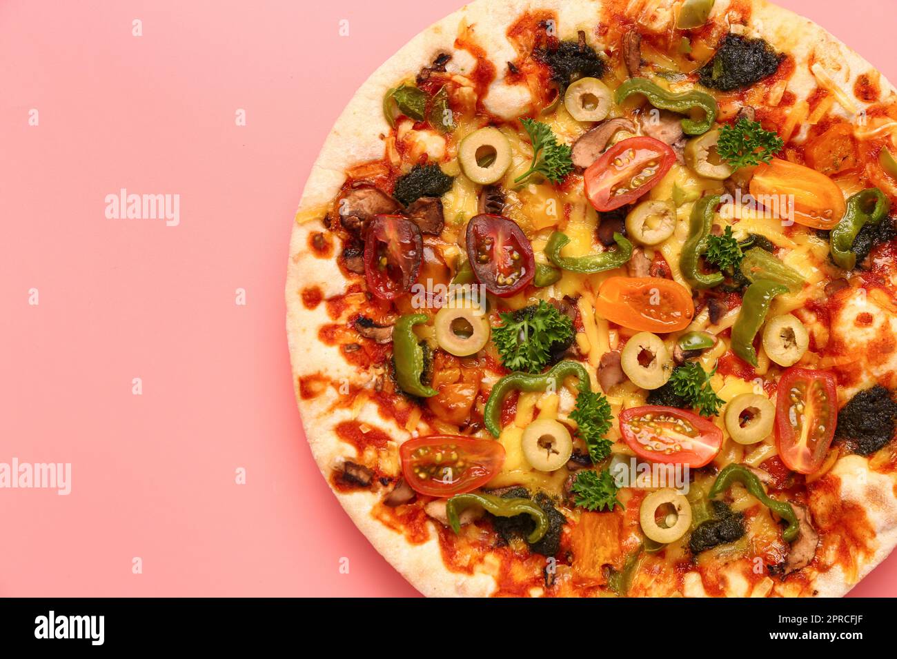 Vegetable pizza on pink background Stock Photo - Alamy