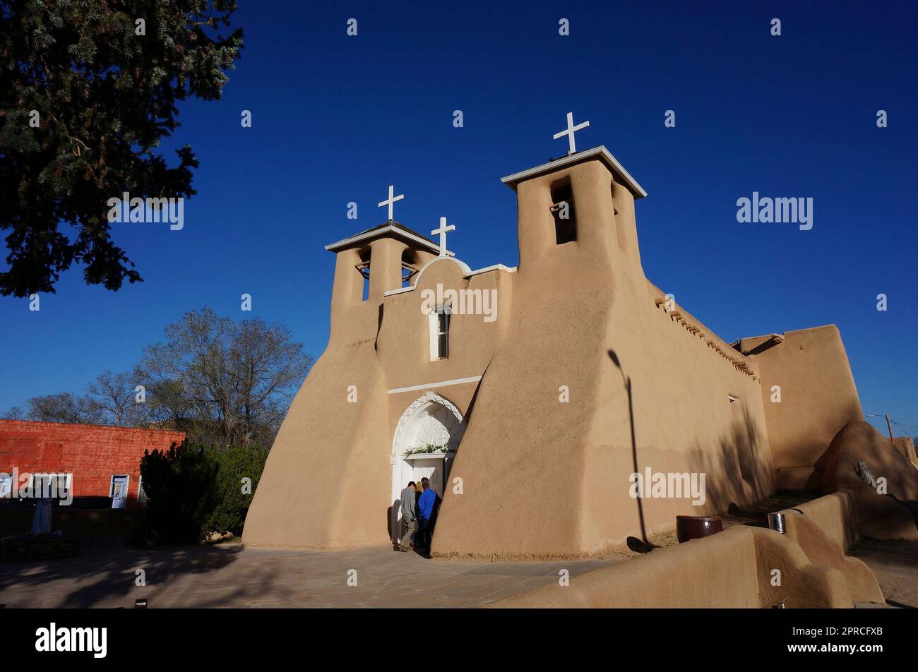 Mass goers enter the San Francisco de Asís Mission Church located in ...