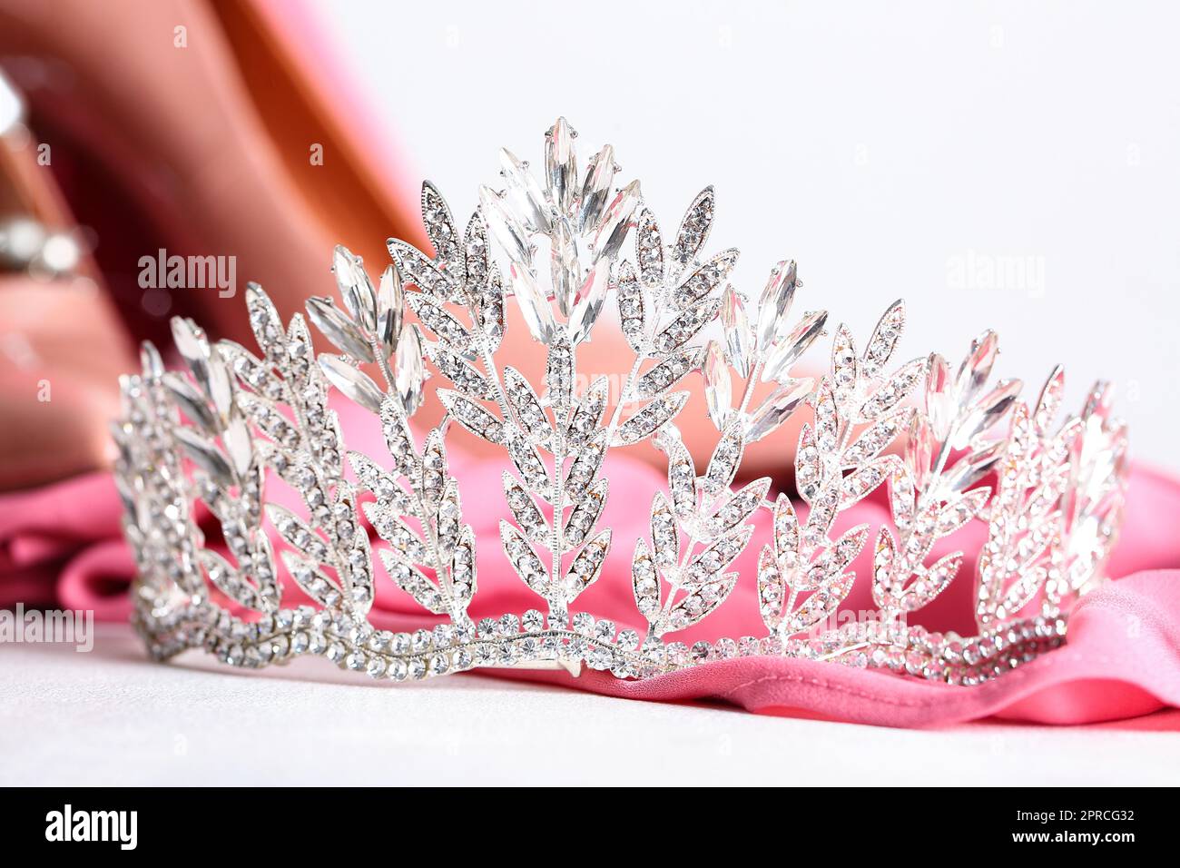 Beautiful tiara with prom dress on white table, closeup Stock Photo - Alamy