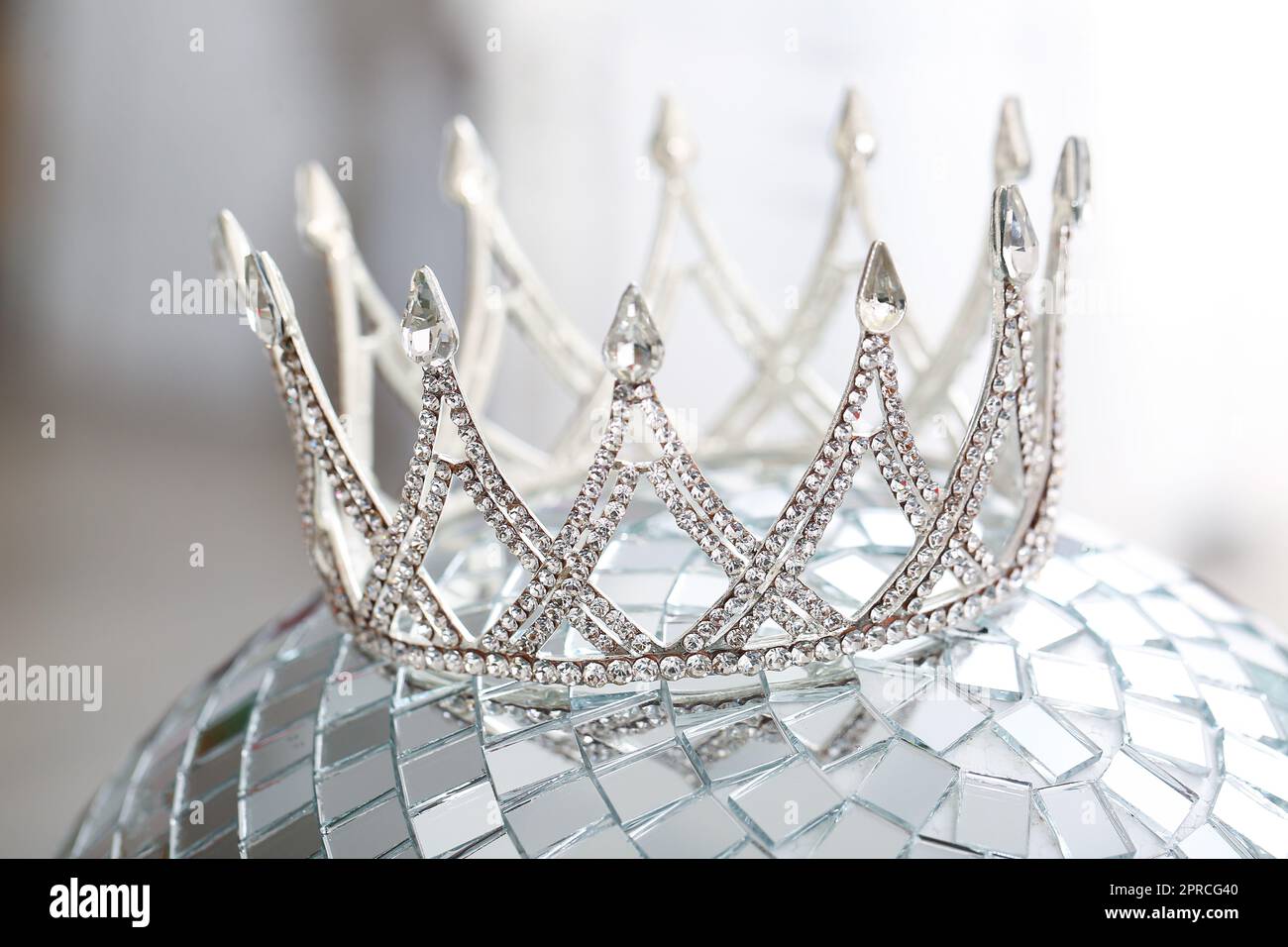 Beautiful crown on disco ball, closeup. Prom concept Stock Photo - Alamy