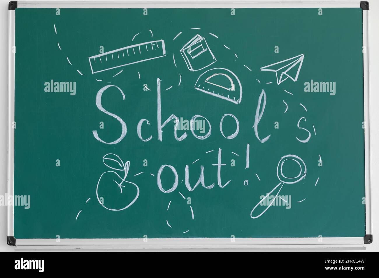 Blackboard with text SCHOOL'S OUT and drawings on light wall Stock ...
