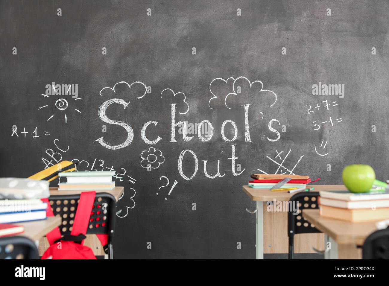 Text SCHOOL'S OUT with drawings on blackboard in classroom Stock Photo ...