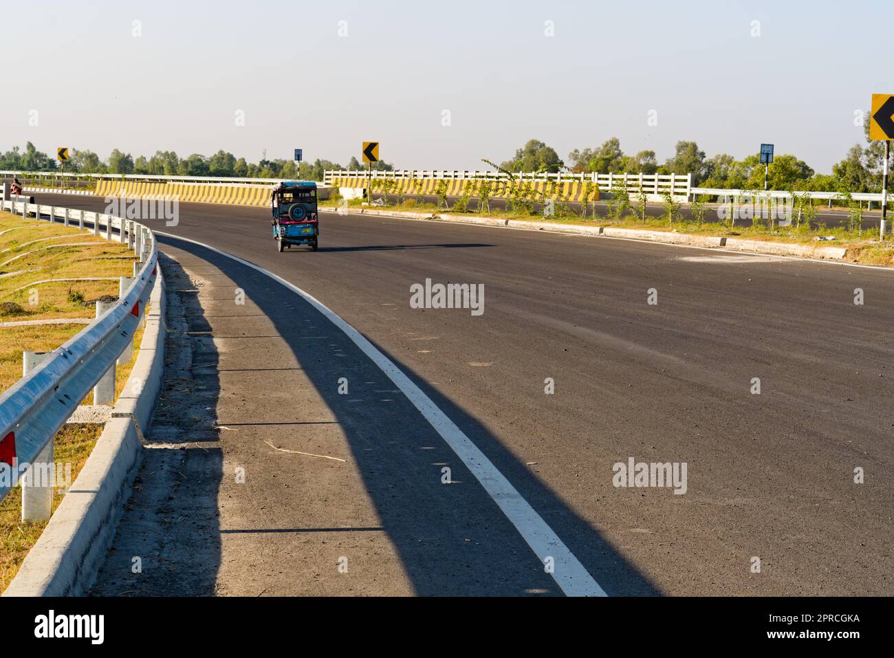 electric three wheeler running on the national highway in India Stock ...
