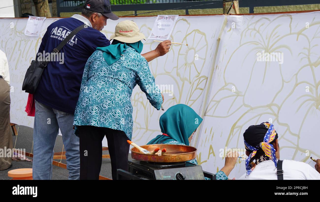 The process of making batik on Festival Batik Keren Blitar. Batik is a ...
