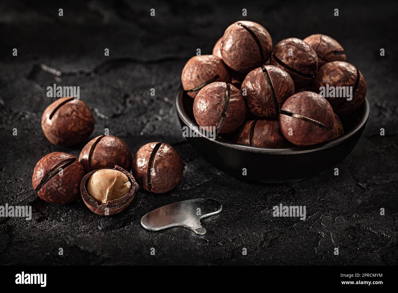 Unpeeled macadamia in bowl hi-res stock photography and images - Alamy