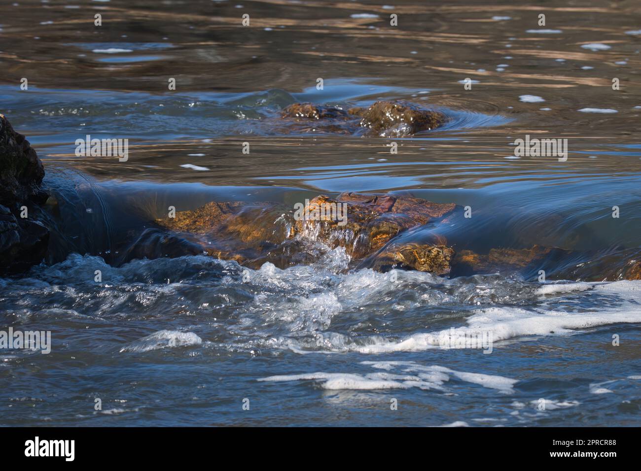 Water Rushing Over Rock Stock Photo - Alamy