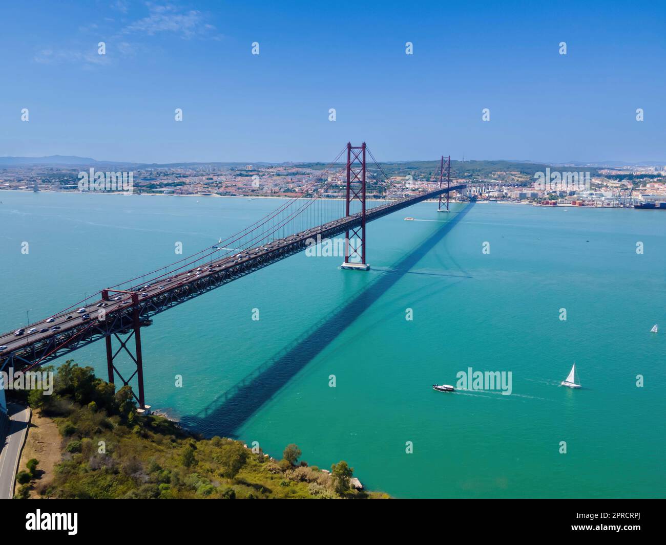 An aerial view of the 25 de Abril Bridge (Portuguese: Ponte 25 de Abril) across the Tagus river ...