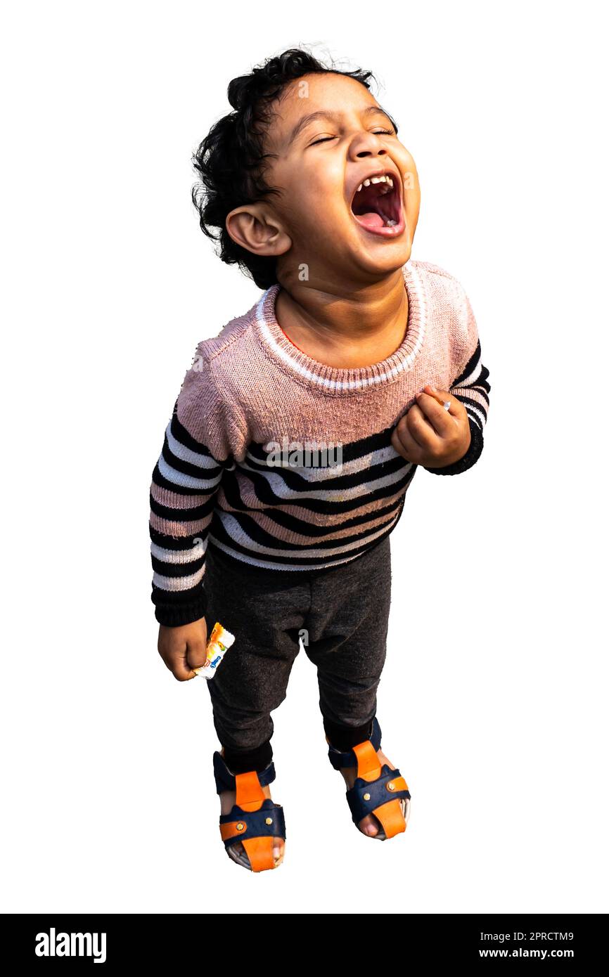 A cute boy laughing at a pretty healthy infant. A cute little boy ...