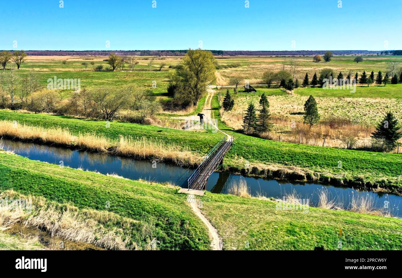 Aerial view of a dam secured drainage ditch with a narrow bridge for ...