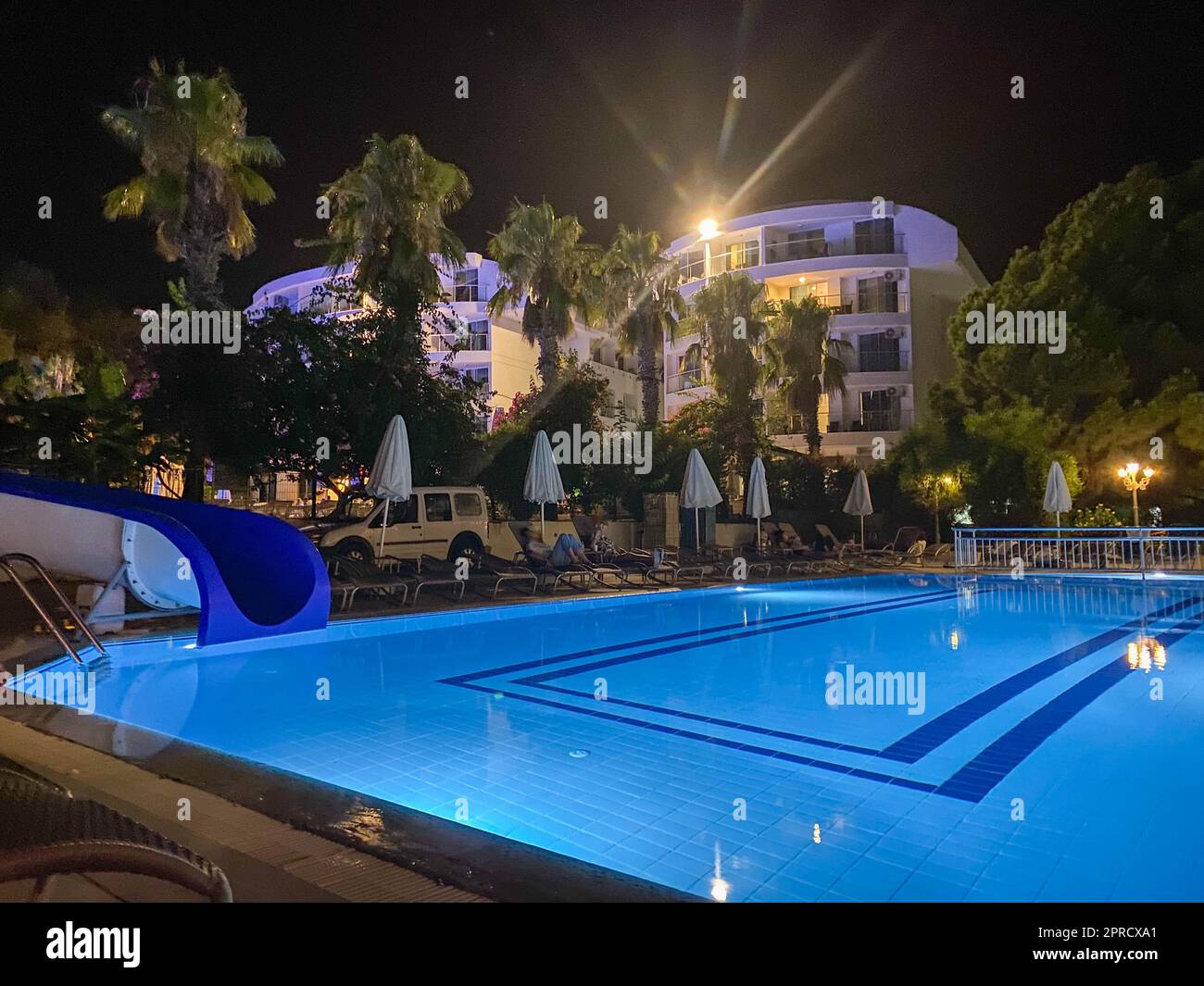 A pretty swimming pool in night at a local resort Stock Photo - Alamy